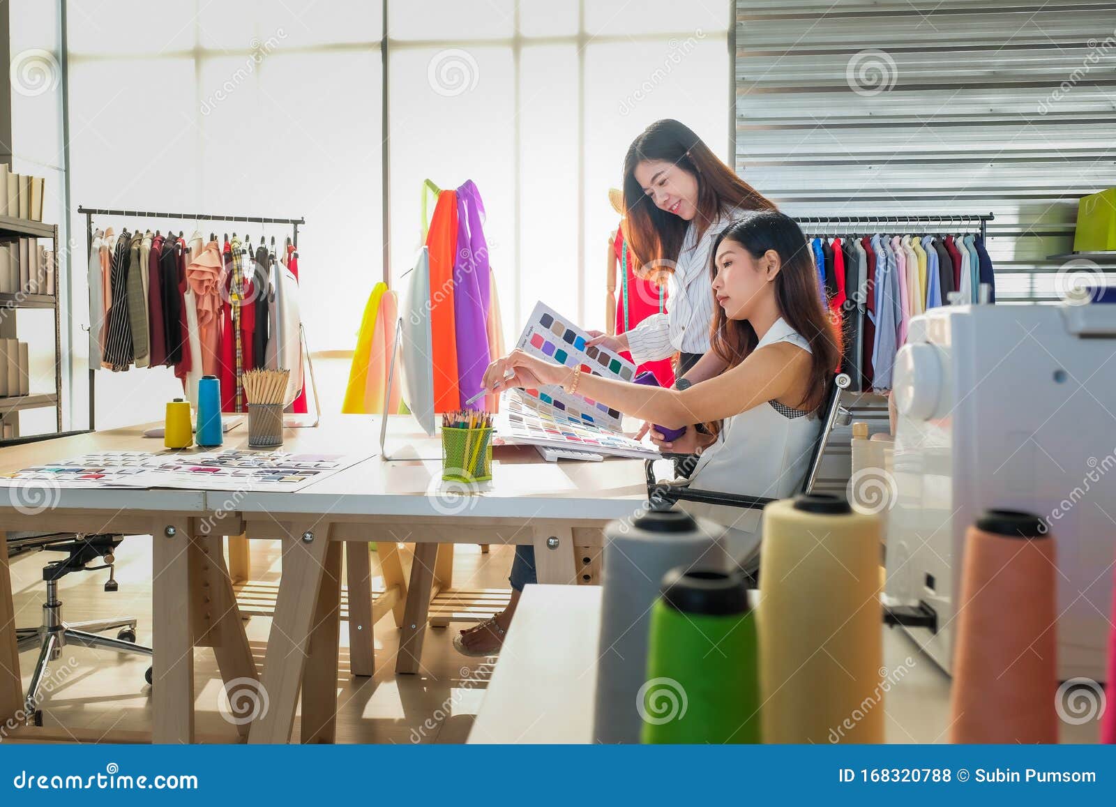 The Designer Is Designing By Comparing Color Chart With The Thread For ...