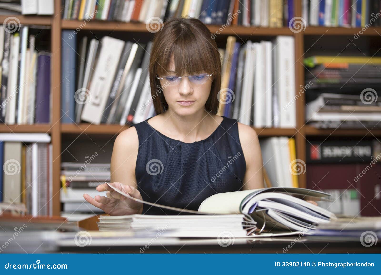 Designer Going through Documents in Library Stock Photo - Image of ...