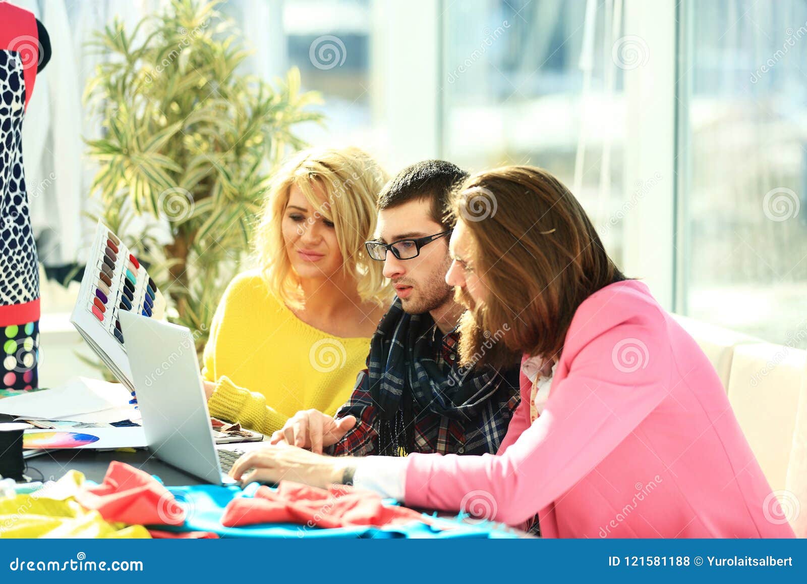 Designer Group Works on a Laptop in a Creative Office Stock Photo ...