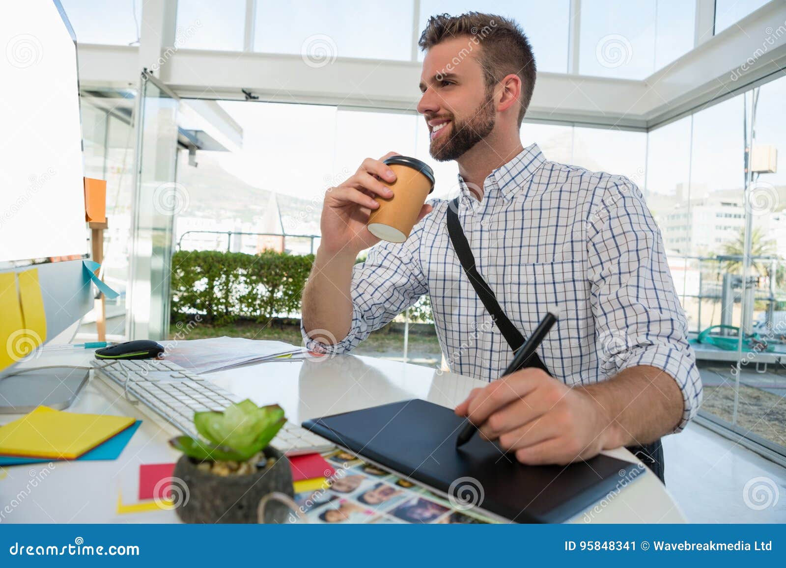 Designer Having Drink Writing on Graphic Tablet at Desk Stock Image ...