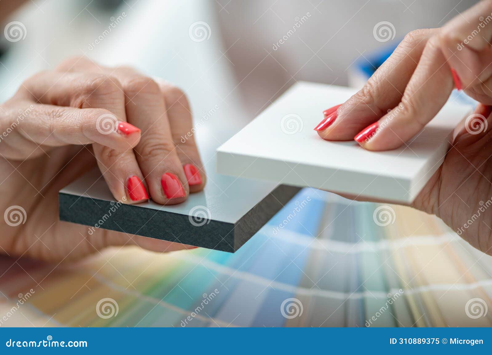 A Designer Holds Up Various Compact Board Samples, Demonstrating ...