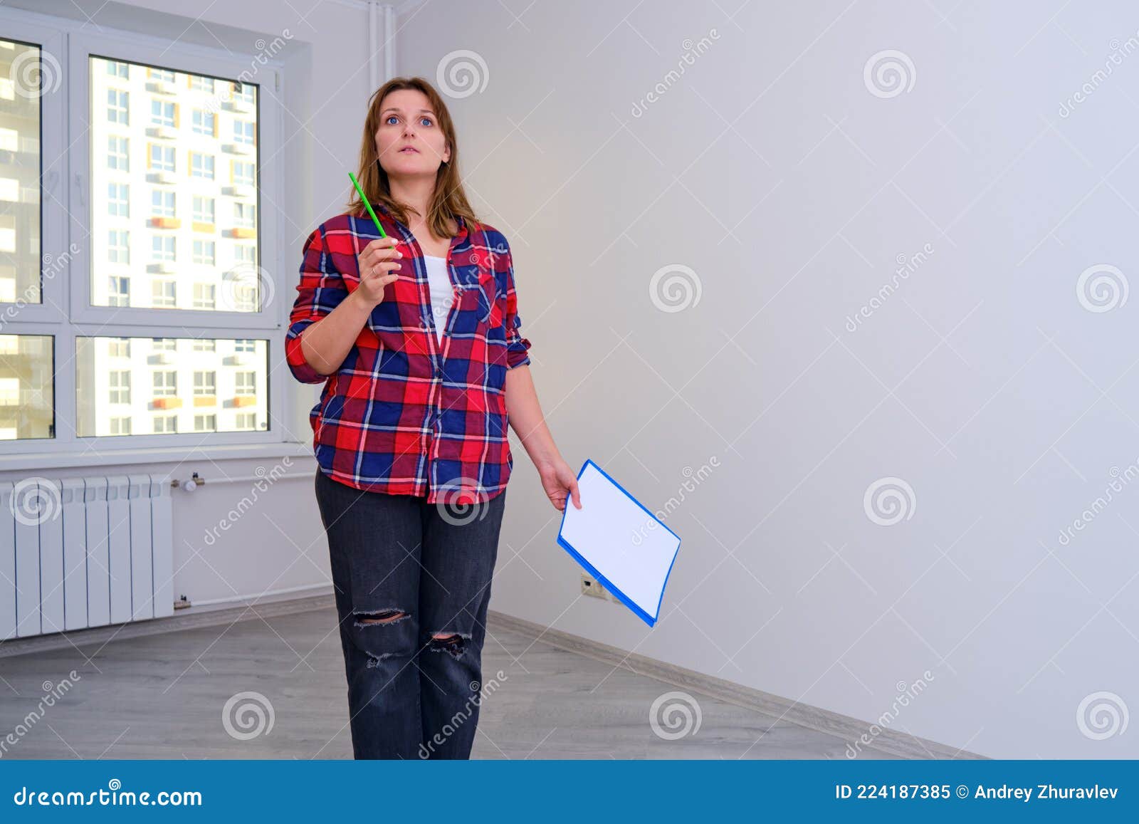 Designer Inspects an Empty House Standing in Front of a Window, Real ...