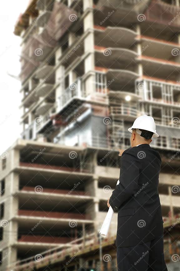 Designer Pointing at Building Under Construction Stock Image - Image of ...