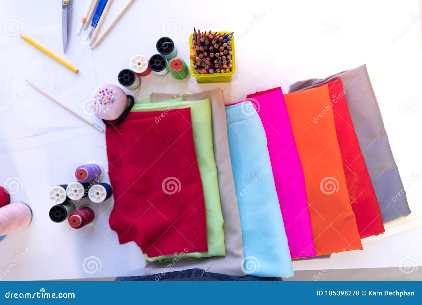 Designer Sewing Tools, Fabric Thread, Pins and Colored Pencils on the ...