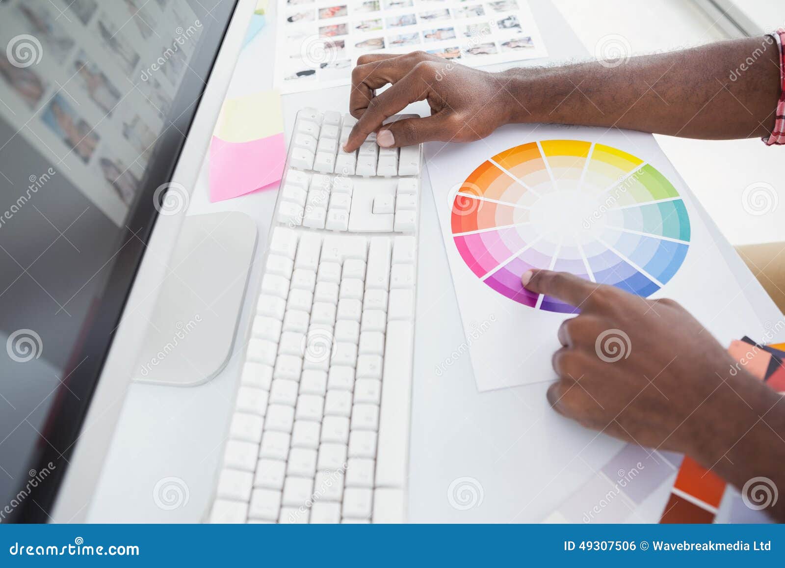 Designer Using a Colour Wheel and Typing on Keyboard Stock Photo ...