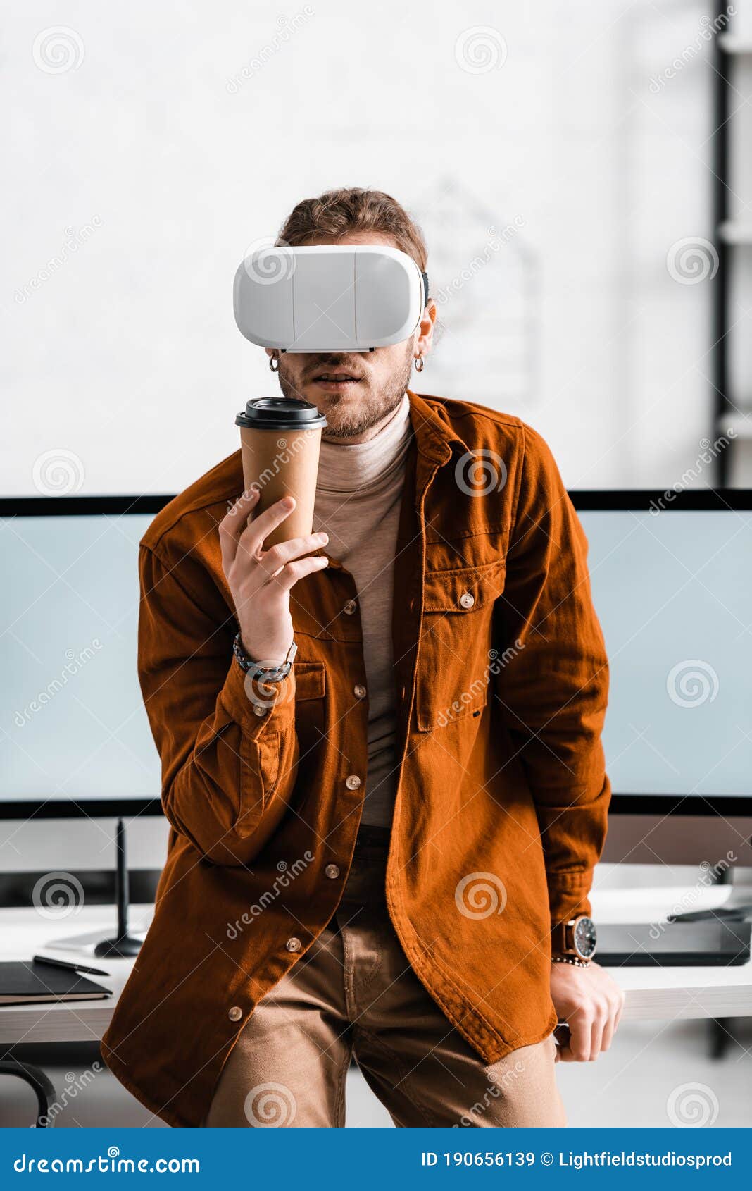 Designer in Virtual Reality Headset Holding Paper Cup Near Computer ...