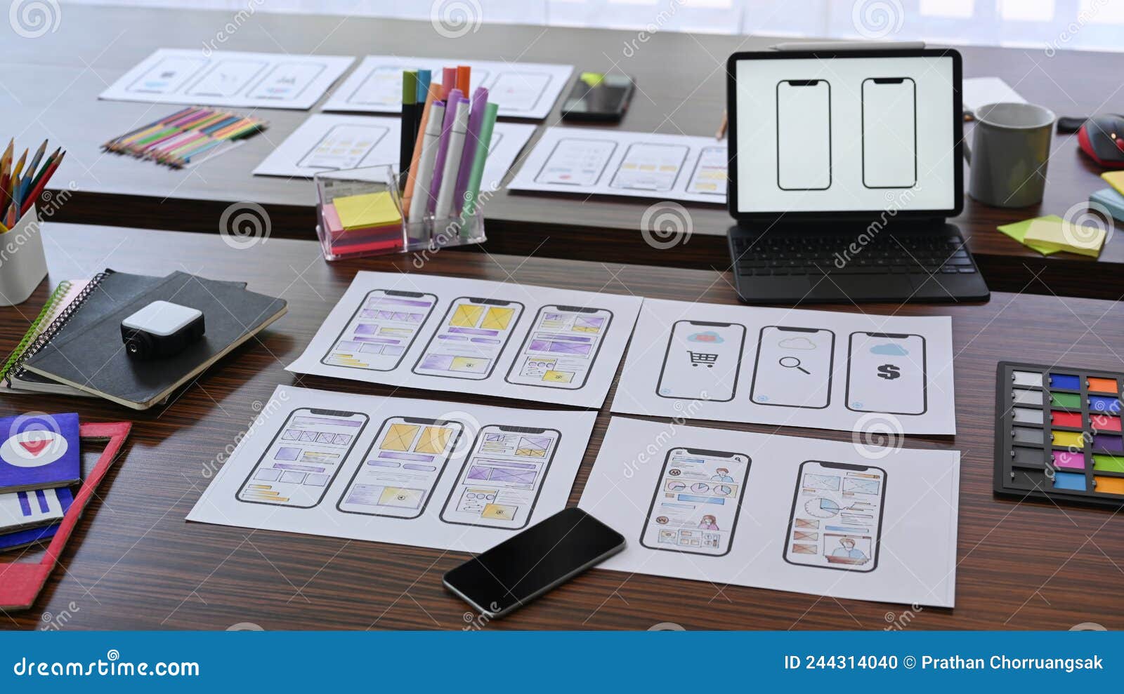 Designer Working Desk with Wireframe Sketches of Screens for Mobile ...