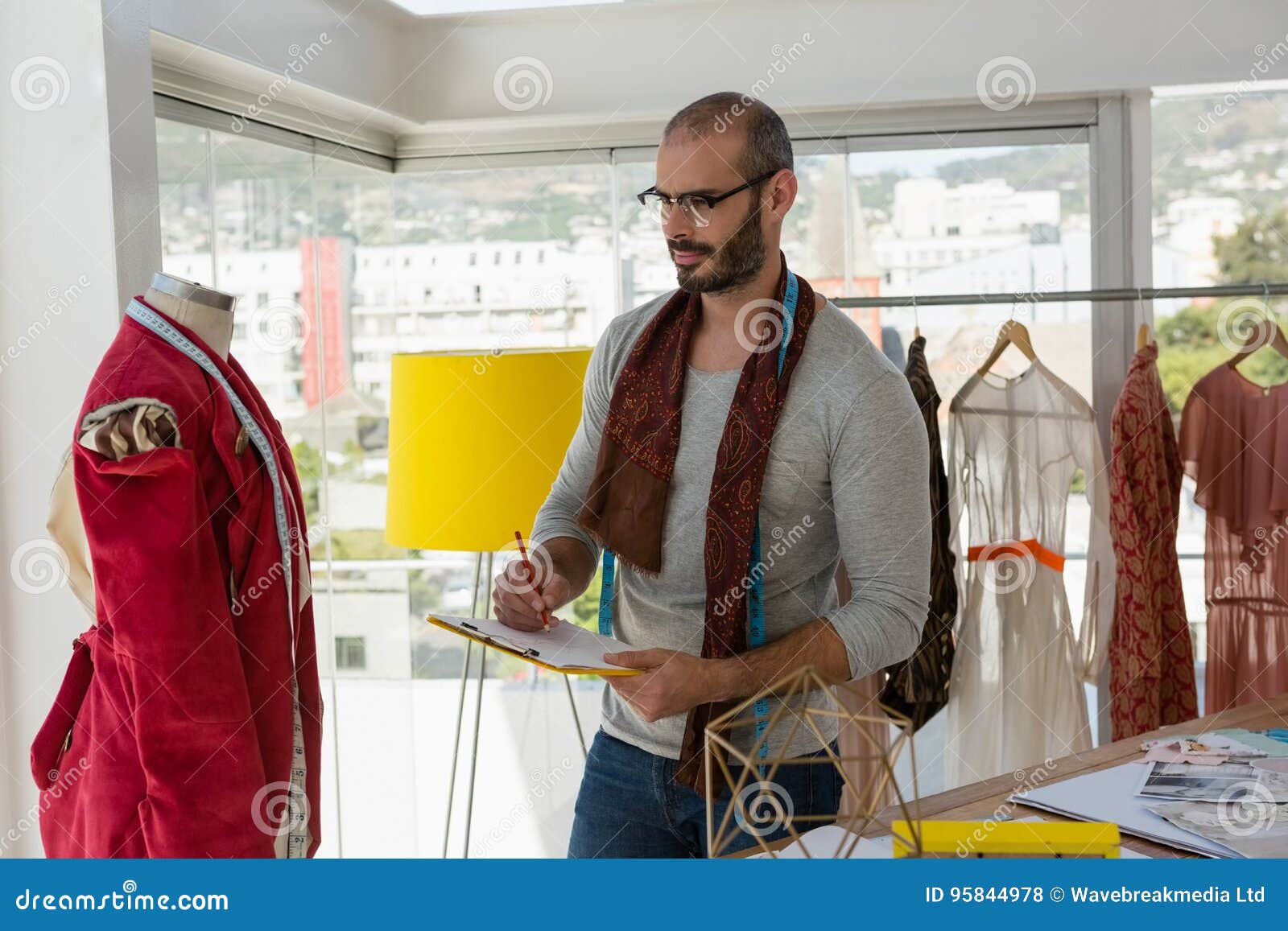 Designer Writing on Paper while Looking at Mannequin Stock Photo ...