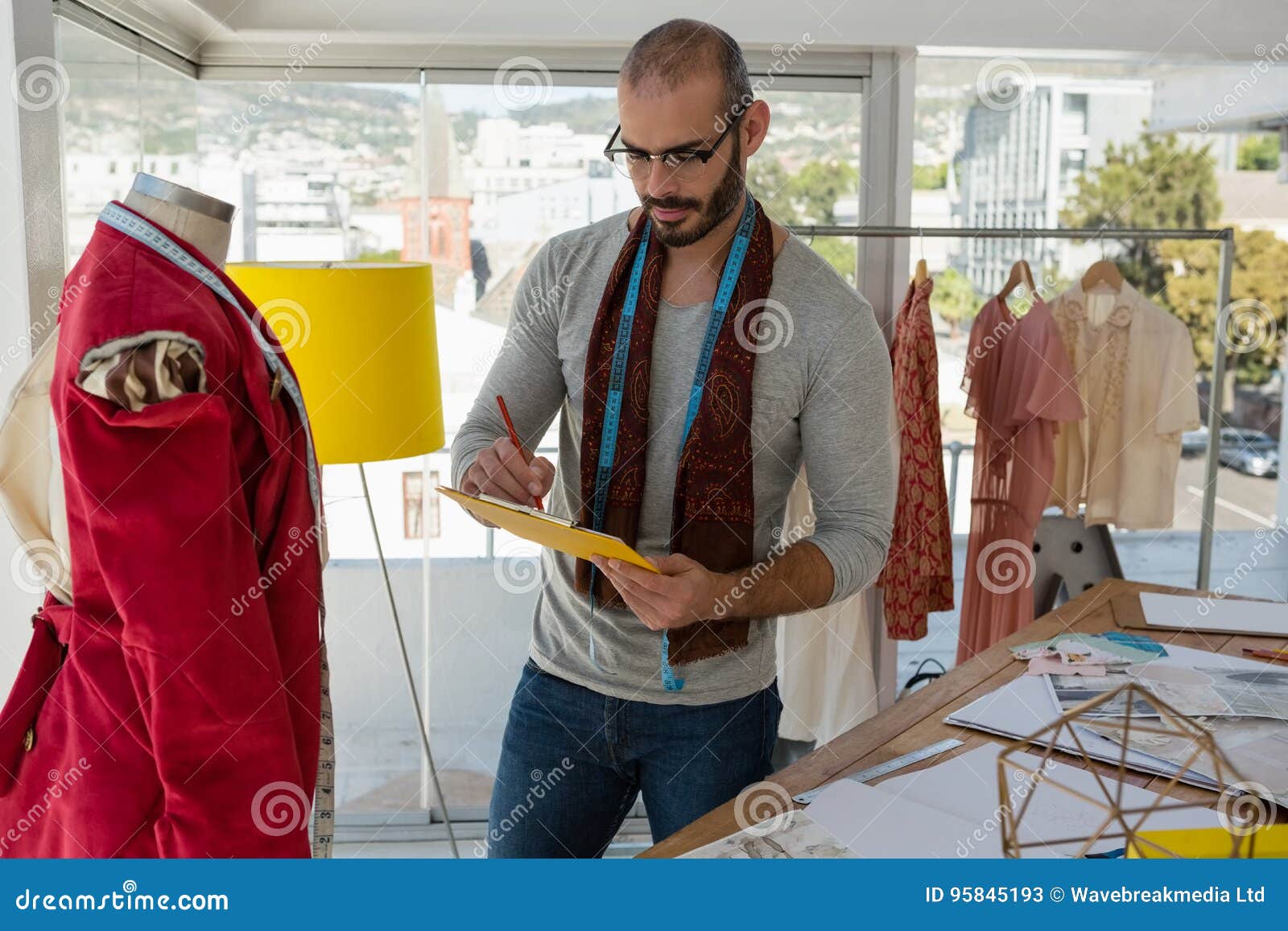 Designer Writing on Paper while Standing by Mannequin Stock Image ...