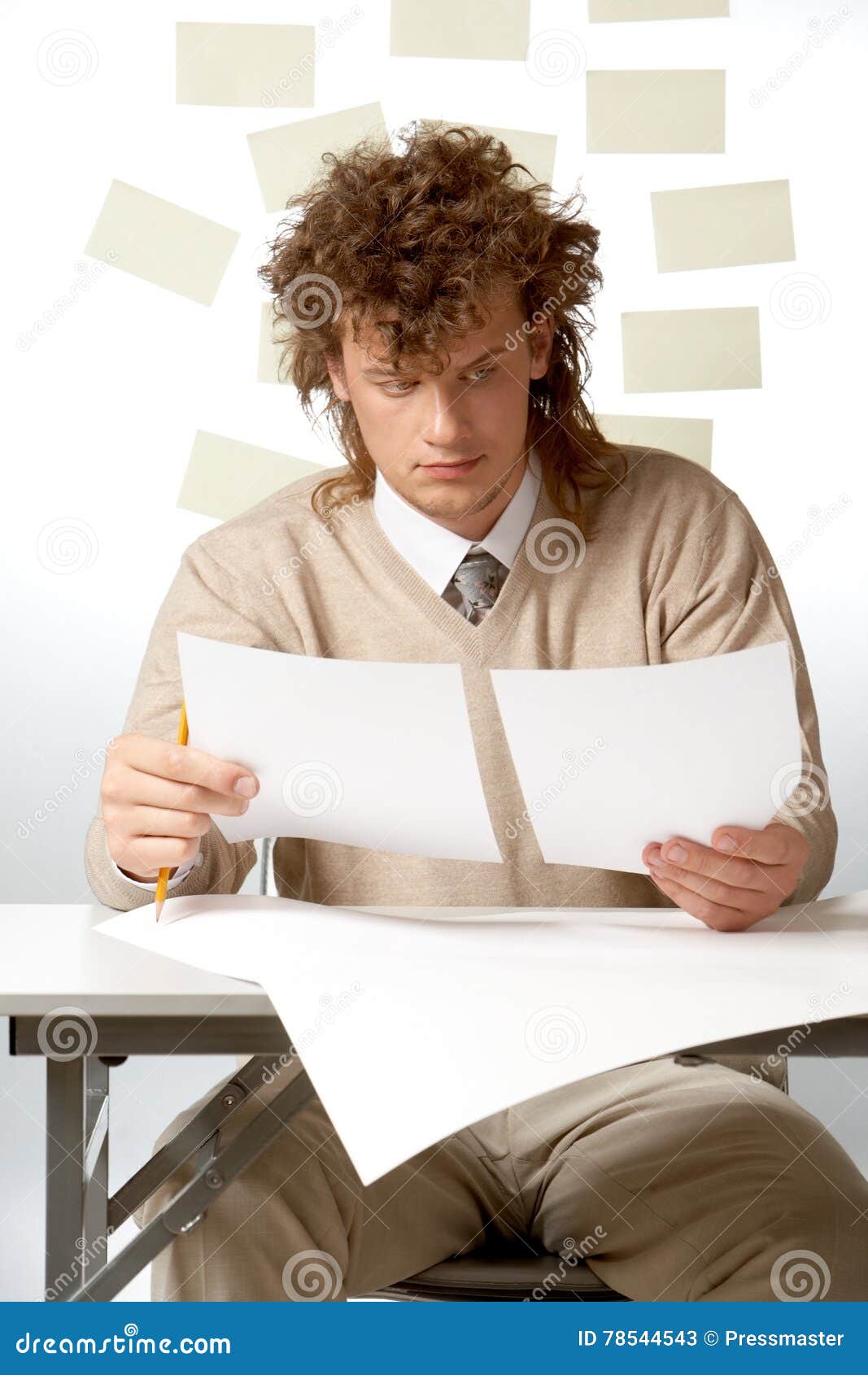 Tousled Man Comparing Two Papers Stock Photos - Free & Royalty-Free ...