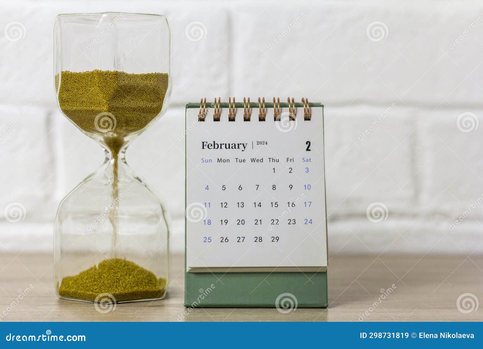 Desk Calendar for February 2024 and a Clock on the Table with Copy ...