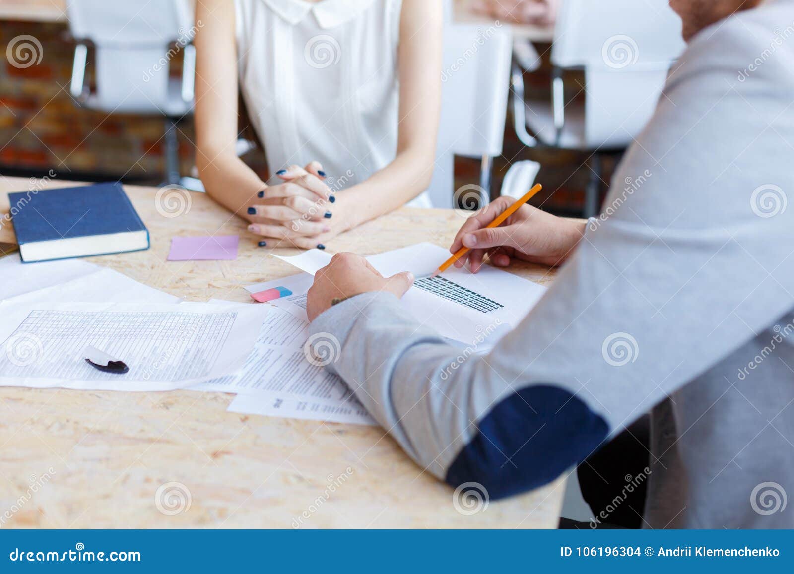A Desk with Documents, Behind Which Sit Two Office Workers. Stock Photo ...