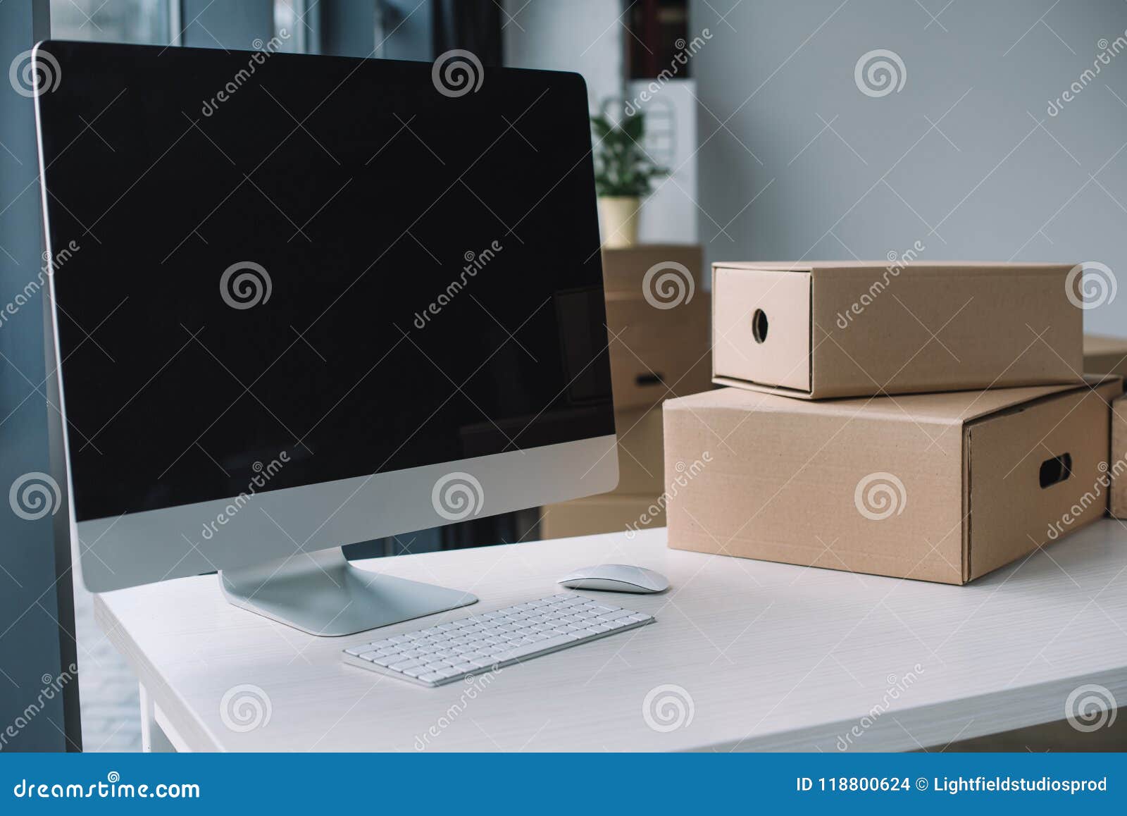 Desktop Computer with Blank Screen and Cardboard Boxes at Workplace ...