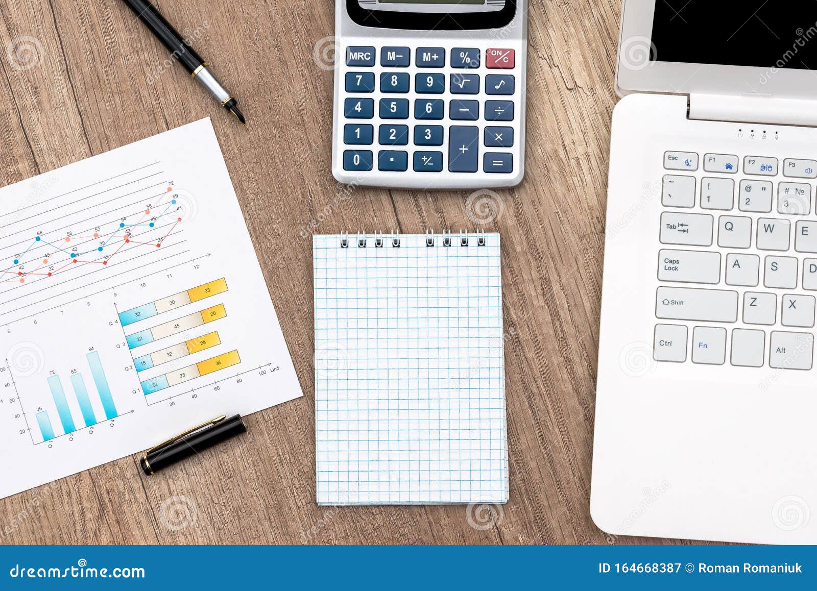 Desktop with Laptop, Calculator, Notepad and Graphic Stock Image ...