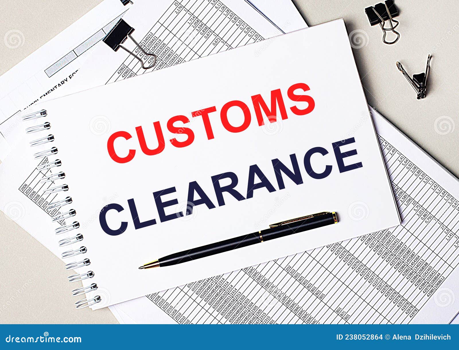 On the Desktop There are Documents, Pen, Black Paper Clips and a ...