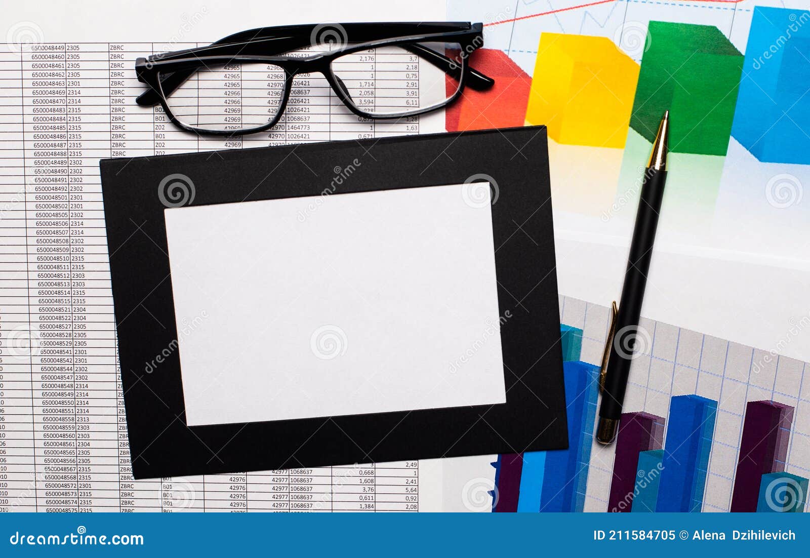 On the Desktop There are Reports, Charts, Black-framed Glasses, a Pen ...