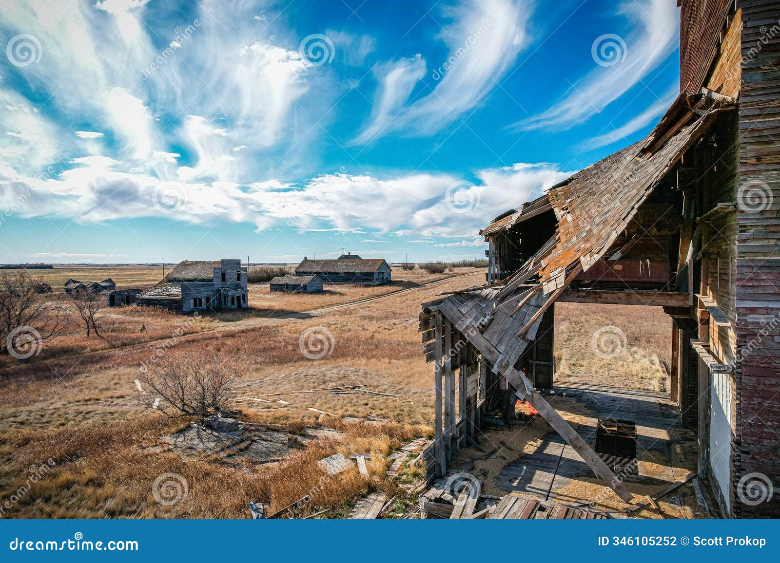A Desolate Landscape with a Few Old Buildings and a Large, Open Field ...