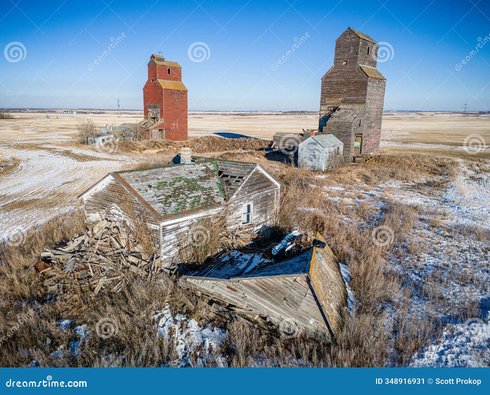 A Desolate Landscape with Two Old Buildings and a Large Empty Field ...