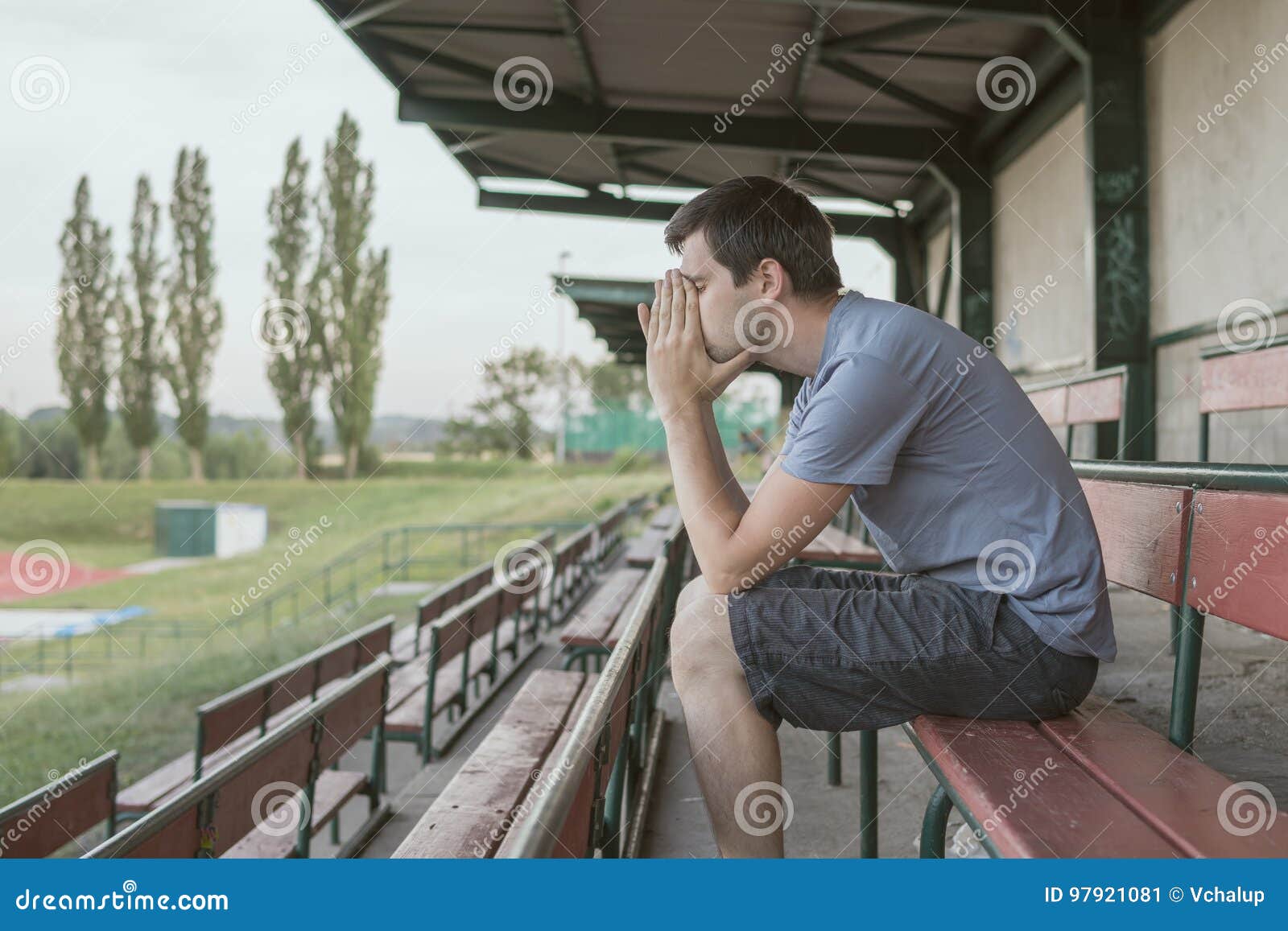 Despair and Depressed Man is Sitting on Bench at Stadium Stock Image ...