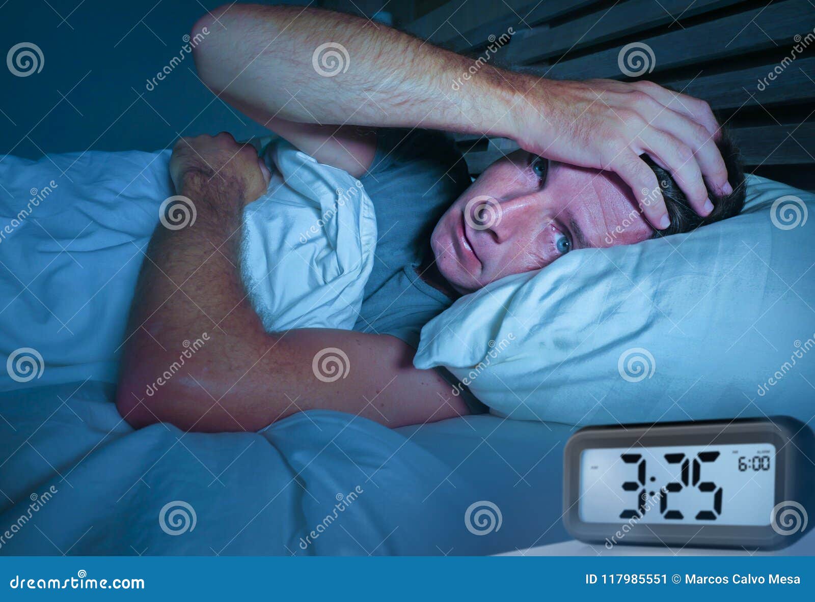 Desperate Man In Stress Sleepless On Bed With Eyes Wide Opened