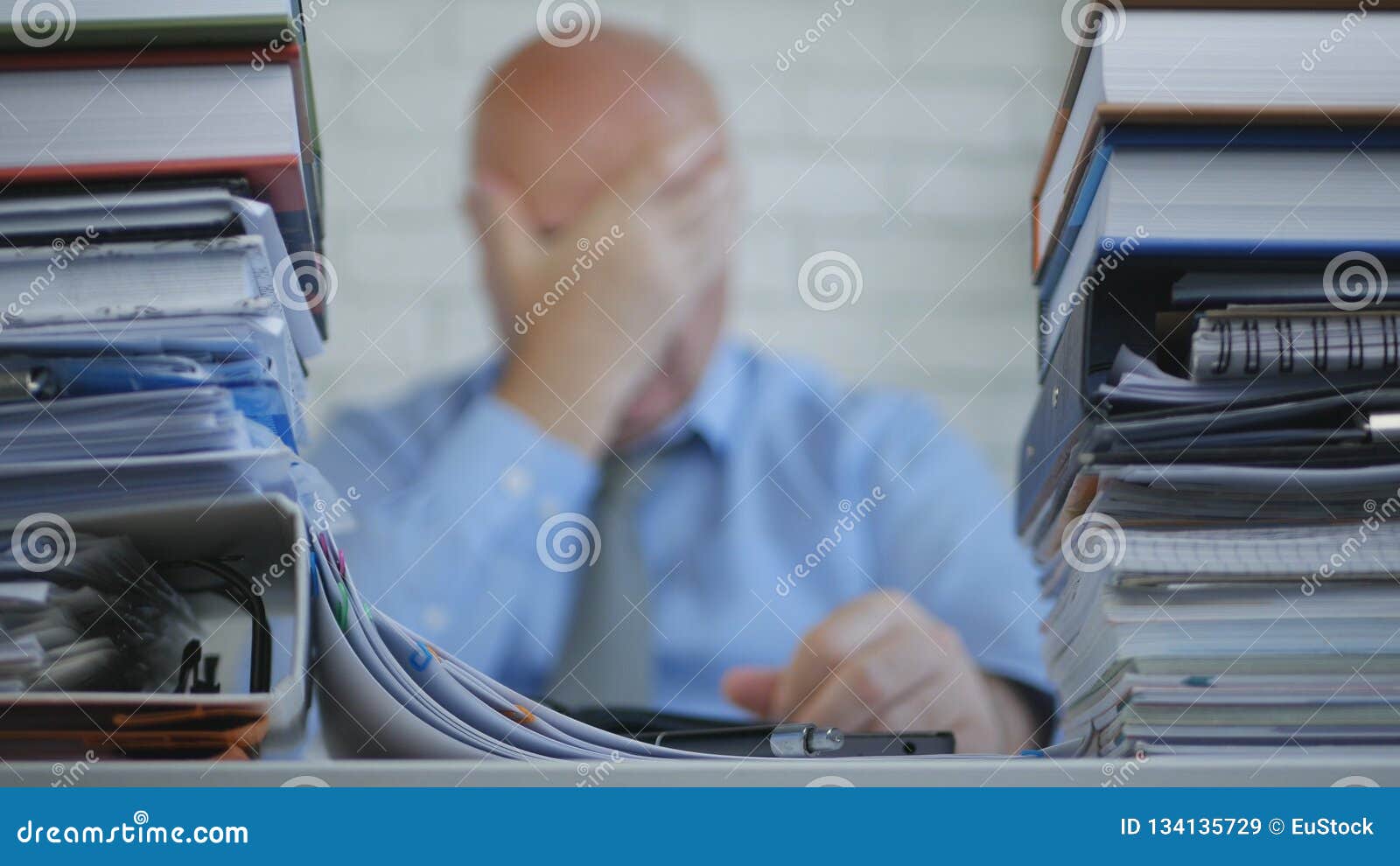 Desperate and Worried Manager Keeping His Head in Hands in Blurred ...