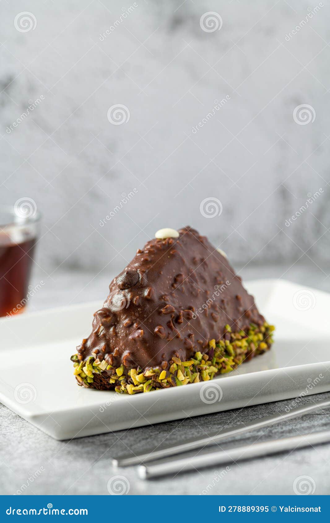 Dessert Cake from Malaga on Stone Table. Cake with Banana Inside, Covered with Chocolate Sauce ...