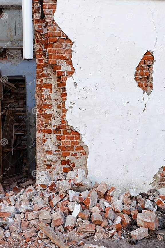 Destroyed Building with a Damaged Wall and a Pile of Broken Brick Stock ...