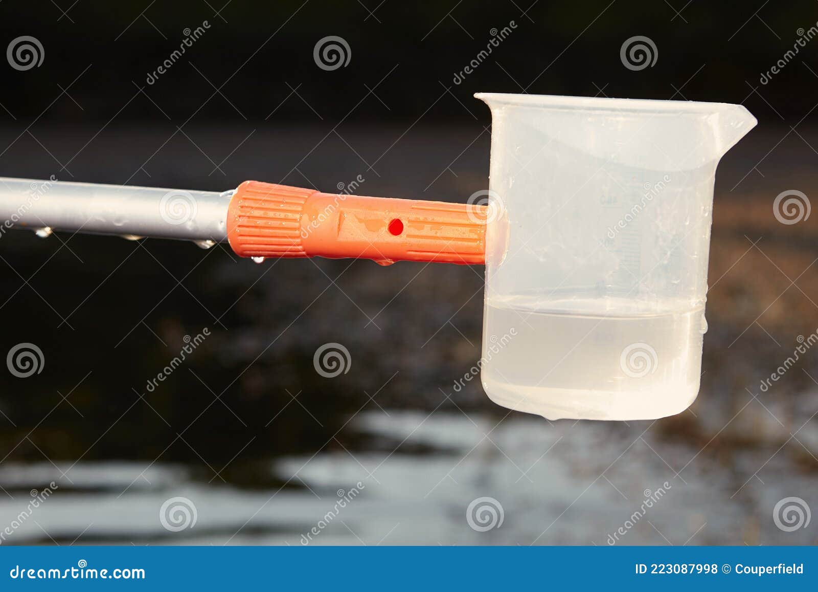 Detail of Plastic Sampling Beaker on Rod with Sample of Water Stock ...