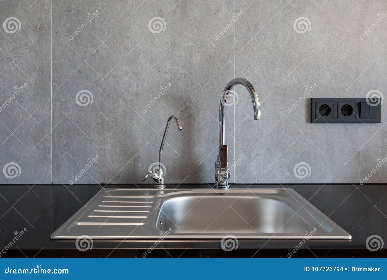 Detail of a Rectangular Designer Kitchen Sink with Chrome Water Tap ...
