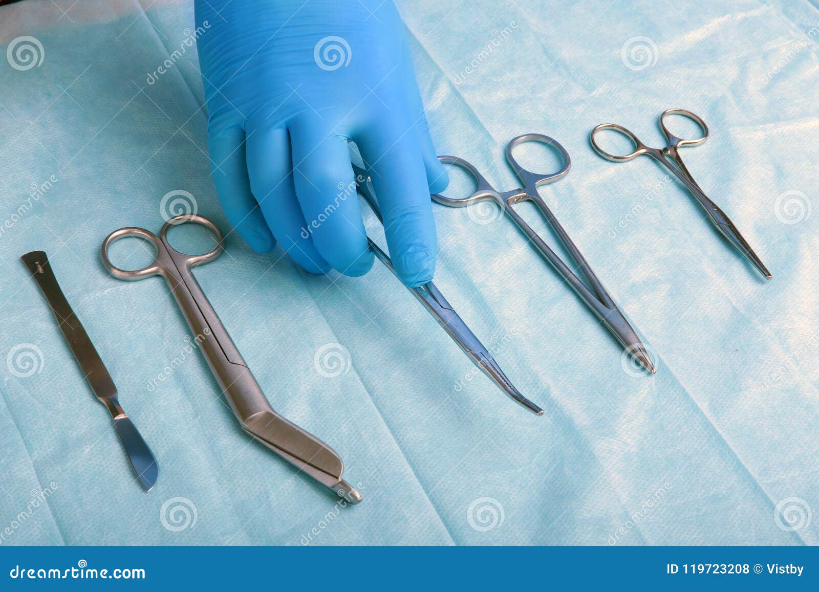 Detail Shot of Sterilized Surgery Instruments with a Hand Grabbing a ...