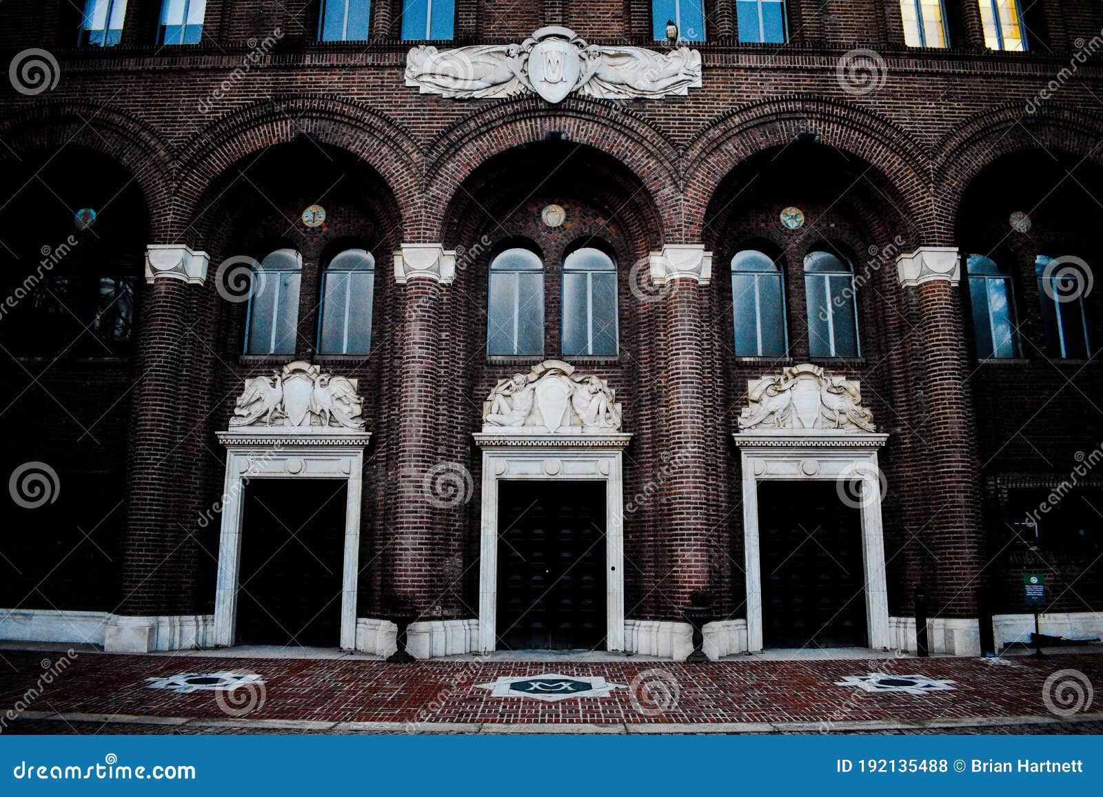 A Detailed Brick Building with Three Large Black Doors Stock Photo ...