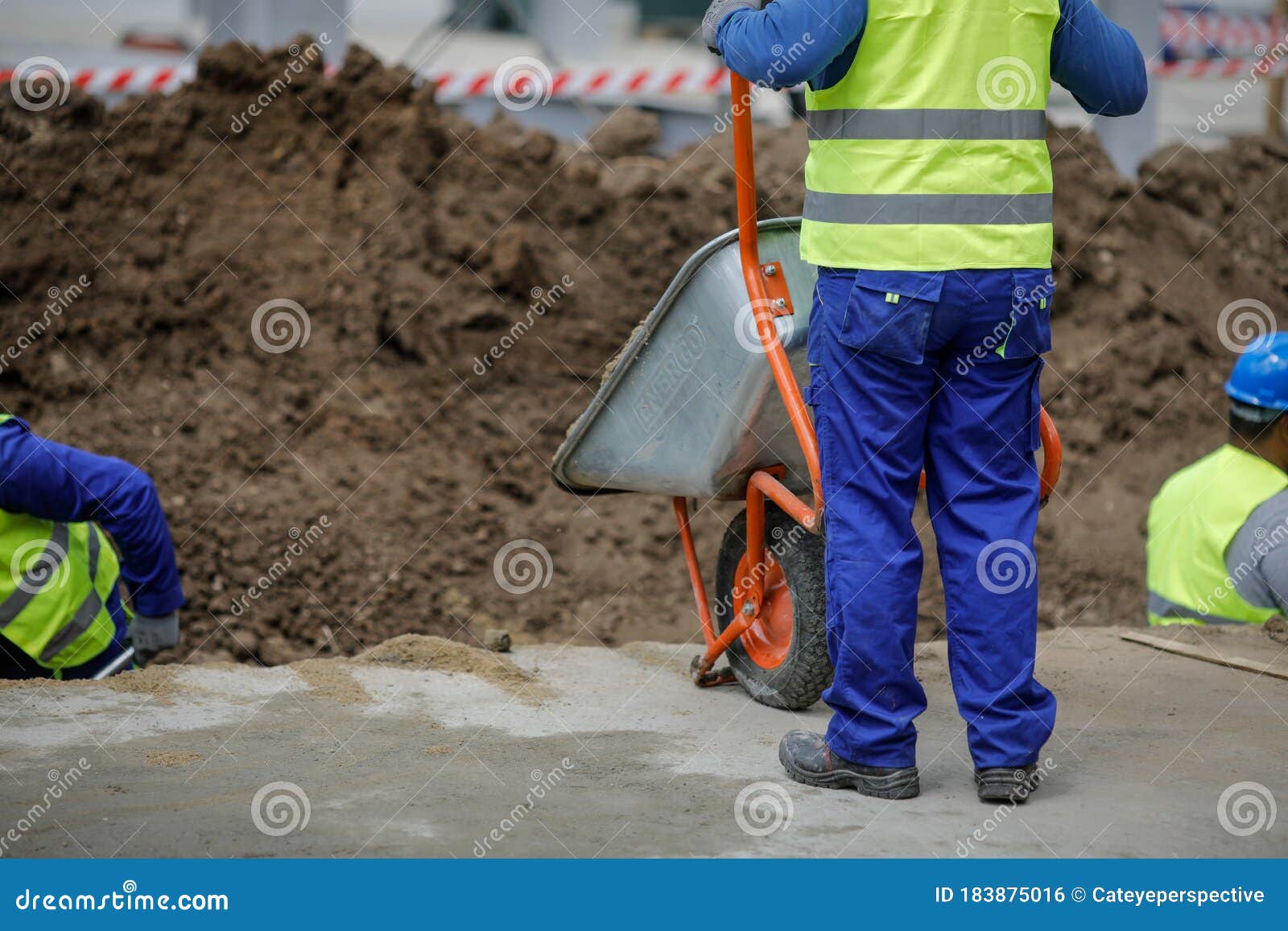 Details with a Construction Worker Pushing a Wheelbarrow on a ...