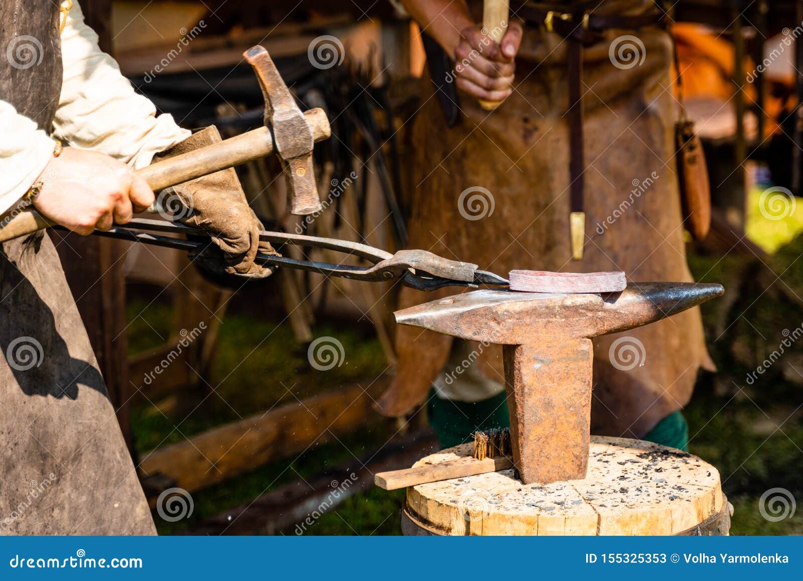 Blacksmith Forges Metal, Holds the Workpiece with Ticks and Hits with a ...