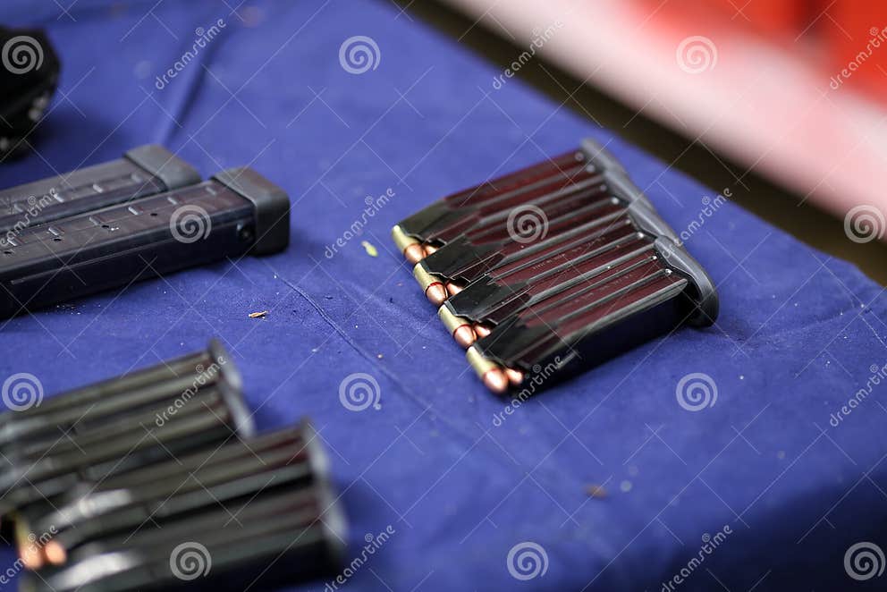 Details with Gun Clips and 9mm Ammunition on a Table on a Shooting ...