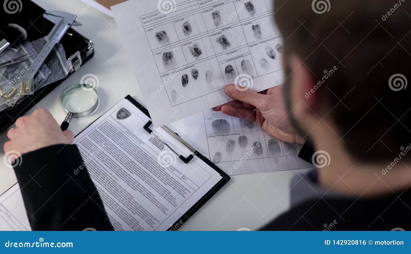Detective Examining Fingerprints Information, Using Magnifying Glass ...