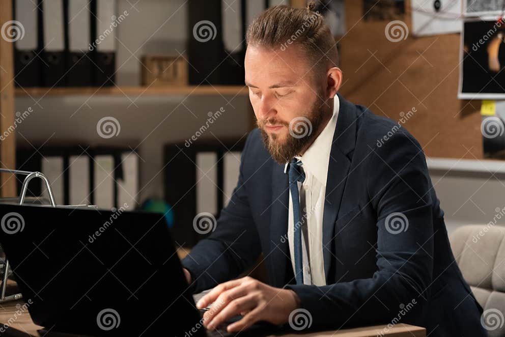 Detective Processing Evidence in Office Using Computer Working at Desk ...