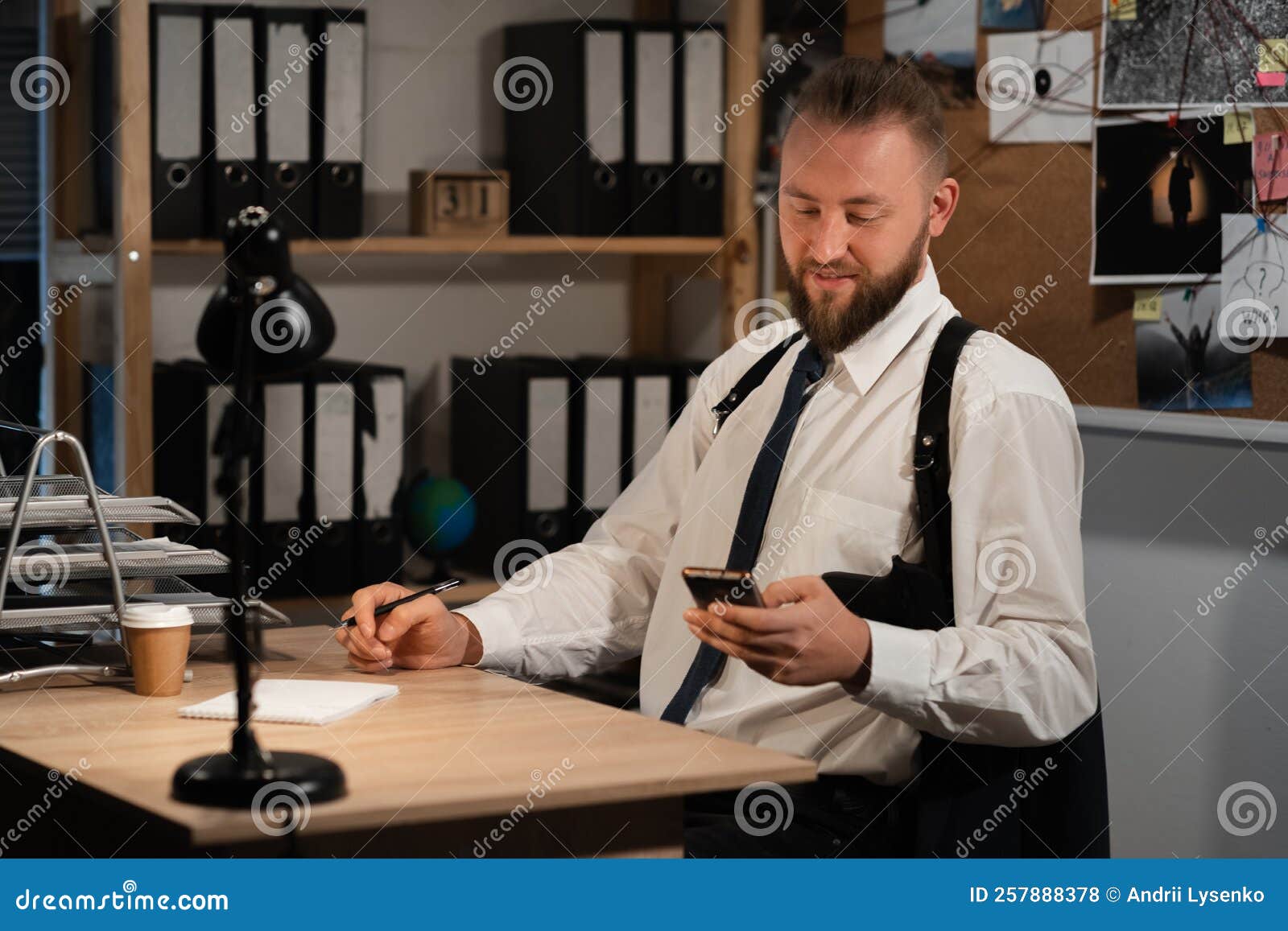 Detective Processing Evidence in Office, Working at Desk Using Mobile ...