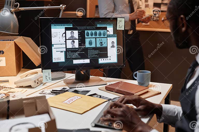 Detective Using Computer at Workplace with Personal Profile on Screen ...