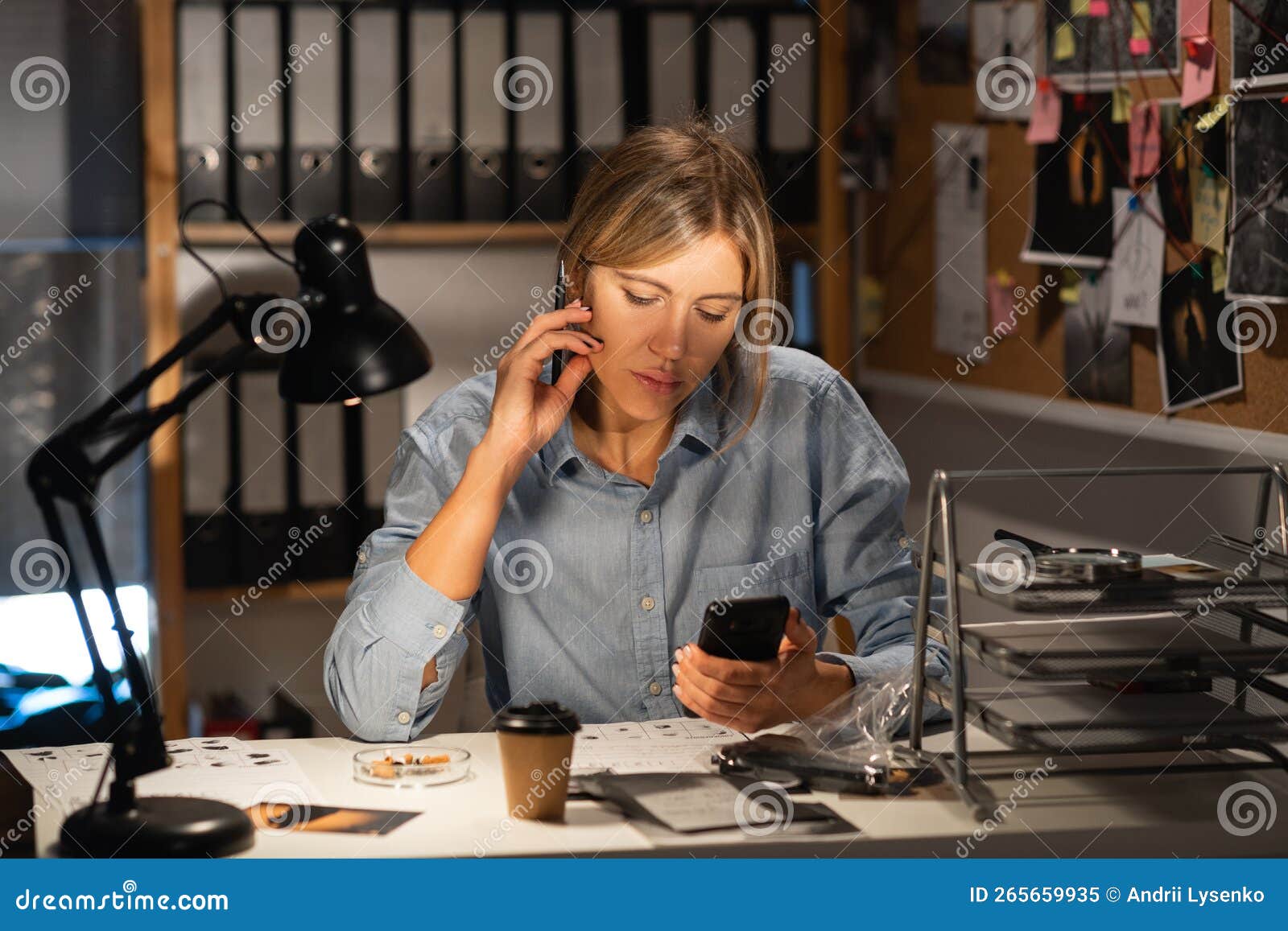 Detective Working at Desk in Her Office Looking at Cellphone. Stock ...