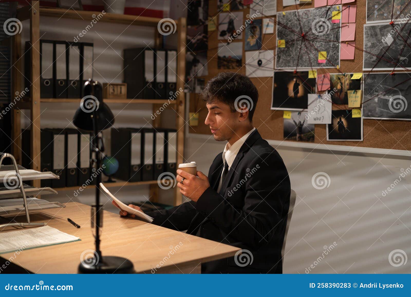 Detective Working at Desk in His Office, Drinking Coffee and Searching ...