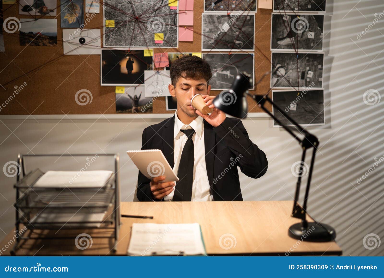 Detective Working at Desk in His Office, Drinking Coffee and Thinking ...