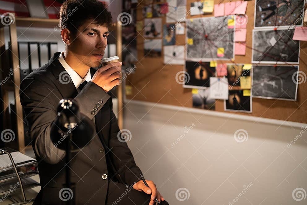 Detective Working in Office is Drinking Coffee Searching of Solution ...