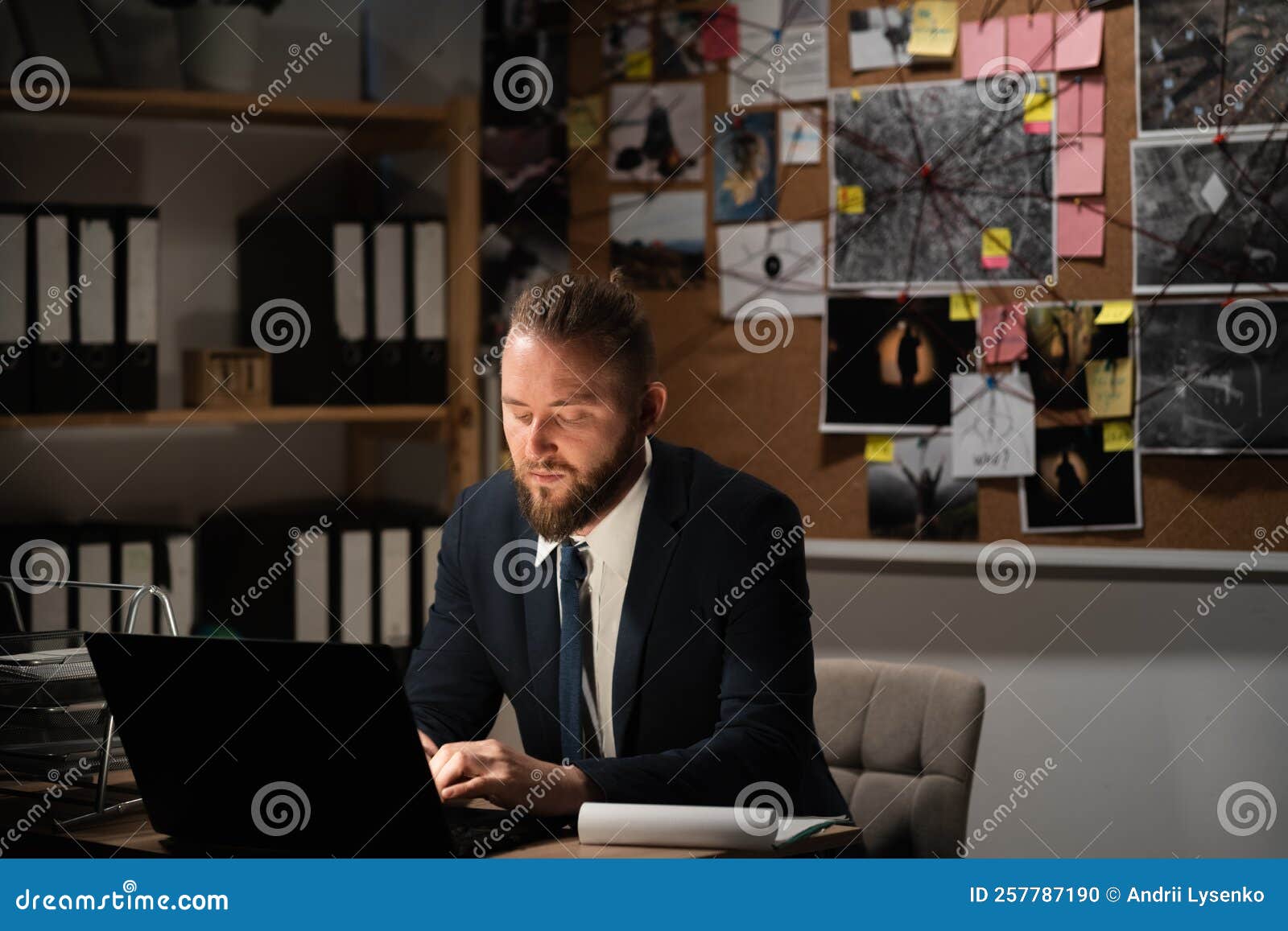 Detective Working in Office Processing Evidence Using Laptop. Stock ...