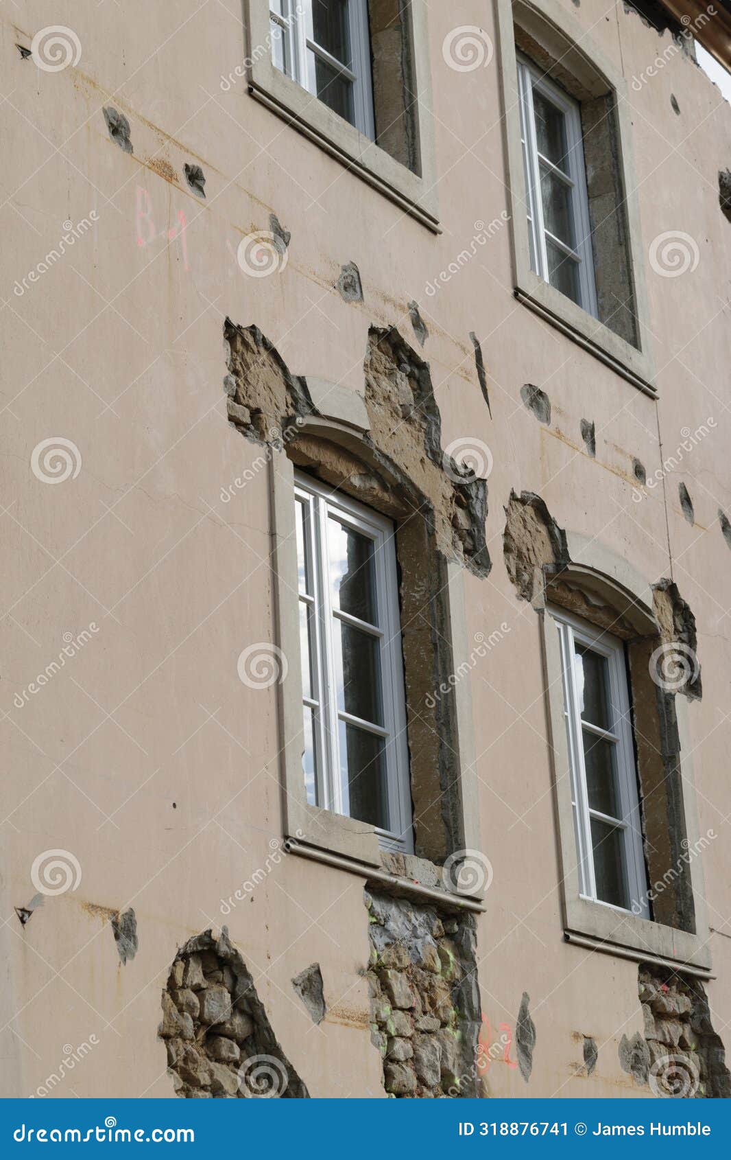 Deteriorating Building Facade with Exposed Bricks Stock Image - Image ...