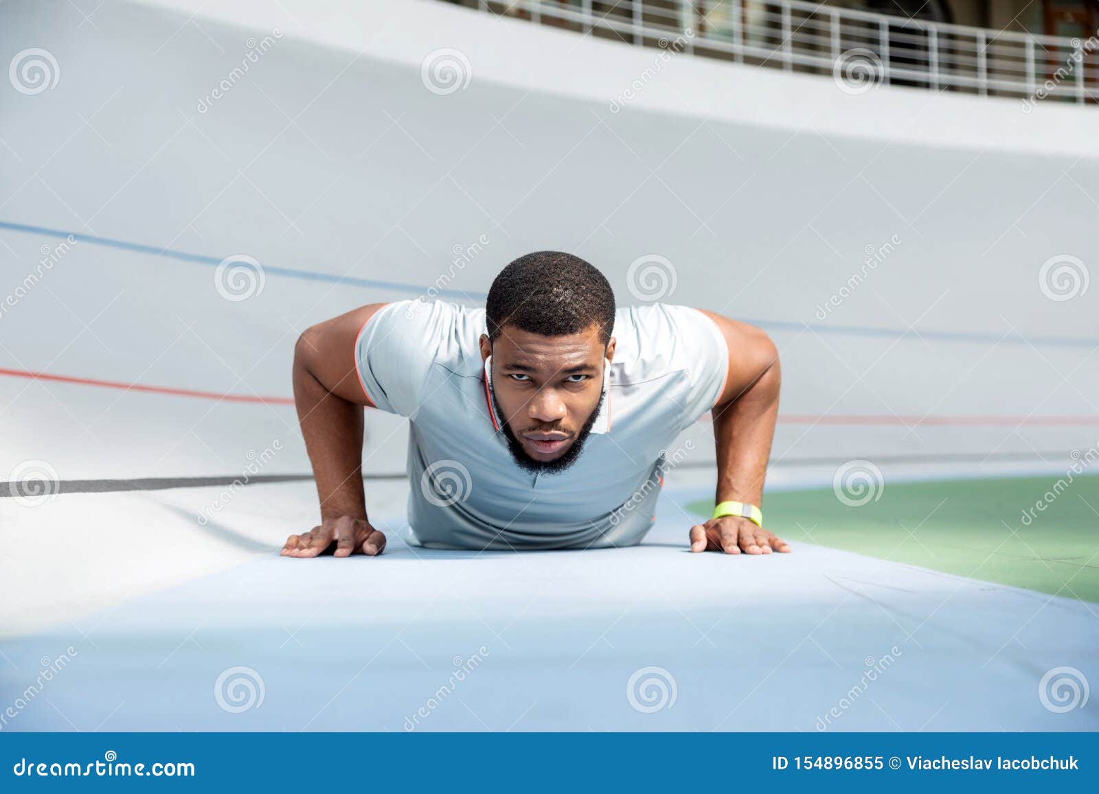 Determined Athletic Man Doing Push-ups at the Stadium Stock Image ...