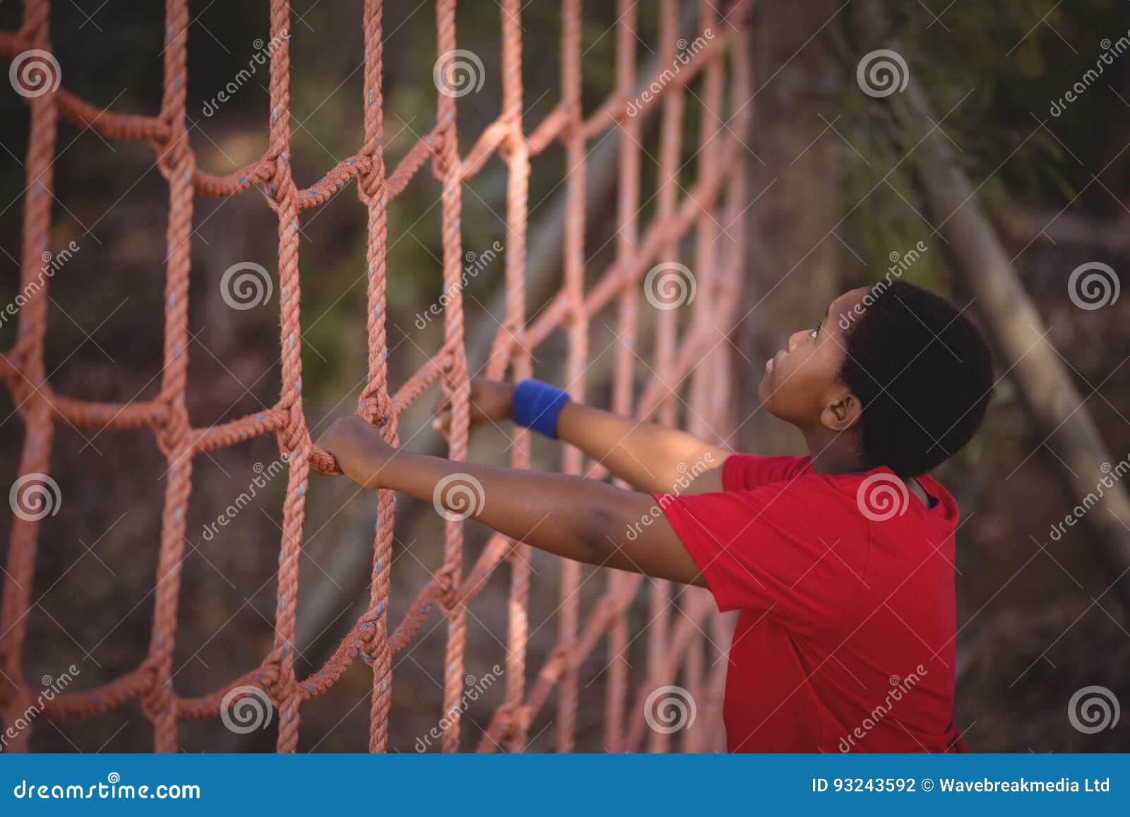 Determined Boy Climbing a Net during Obstacle Course Stock Photo ...