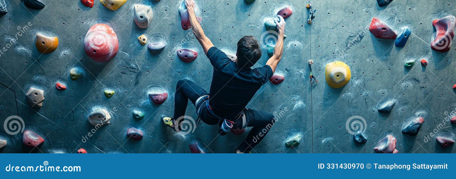 A Determined Climber Ascending An Indoor Rock Wall Showcasing ...
