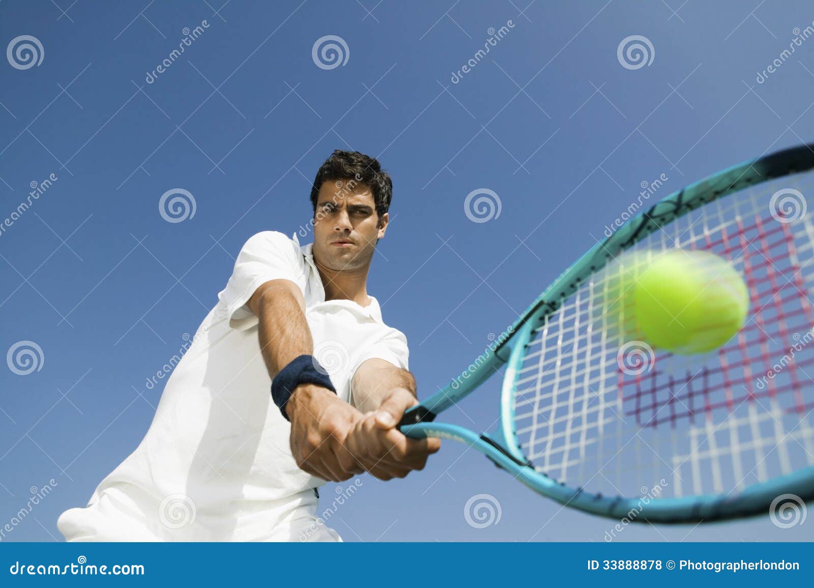 Determined Man Playing Tennis Against Sky Stock Photo - Image of ...
