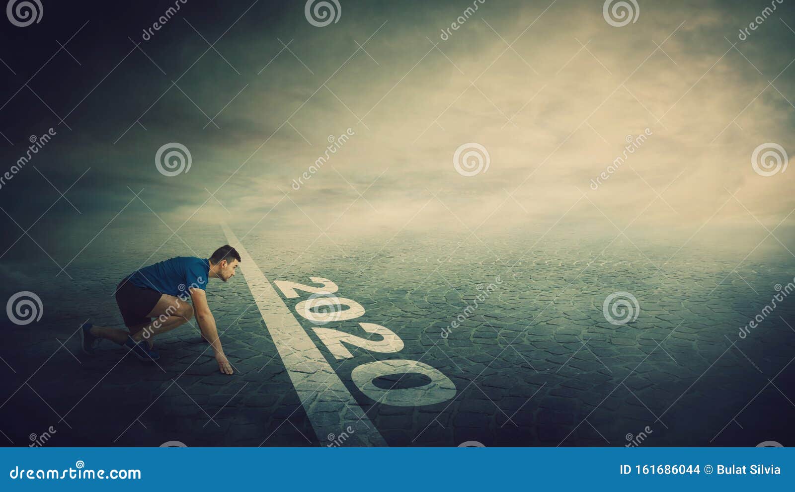 Determined Man Stands in Running Position, at the Start Line, Looking ...