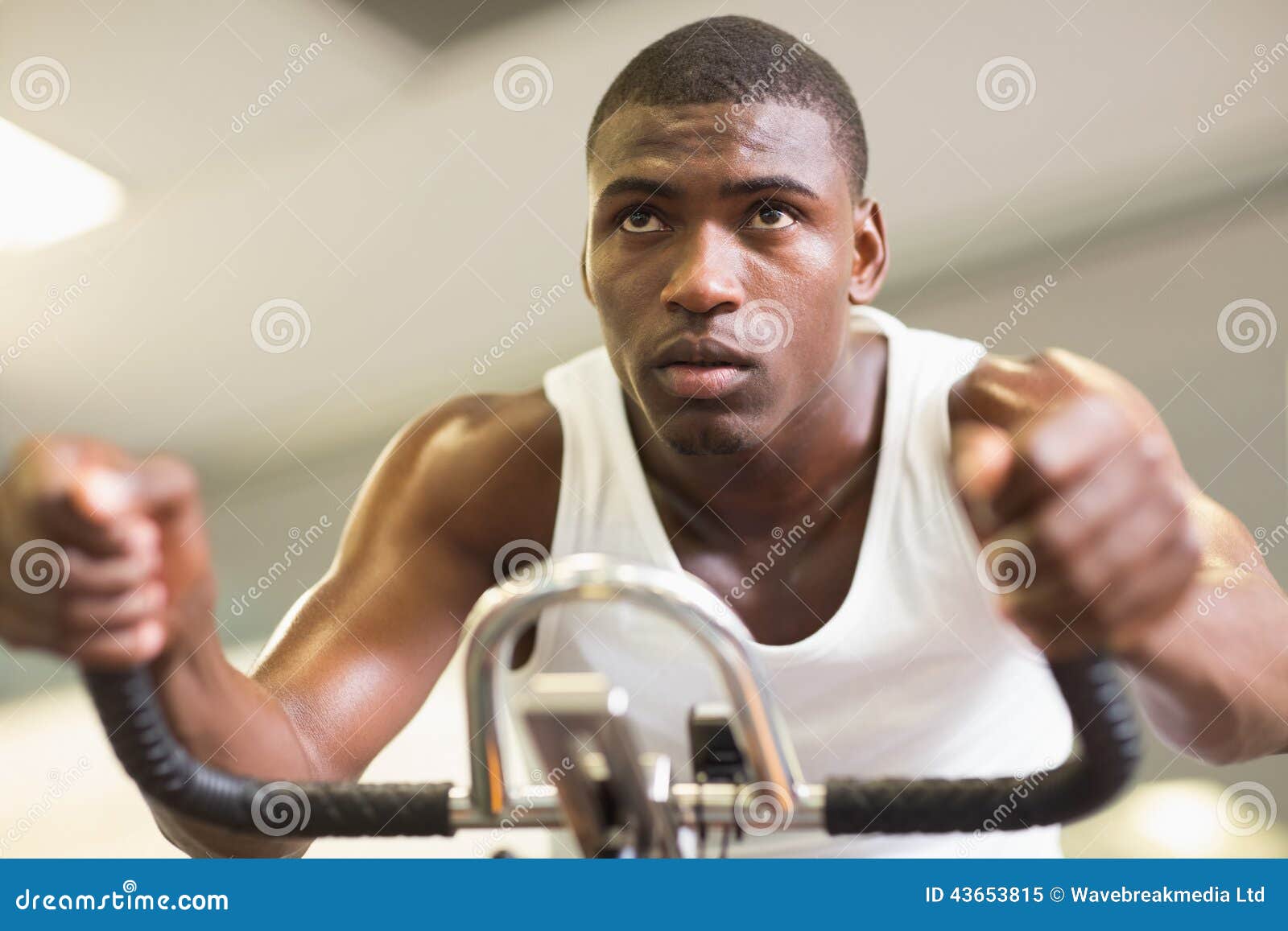 Determined Man Working Out on Exercise Bike at Gym Stock Image - Image ...